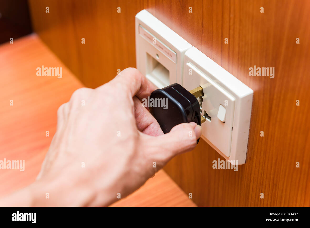 Hand plugging in power plug into socket. Energy concepts Stock Photo ...