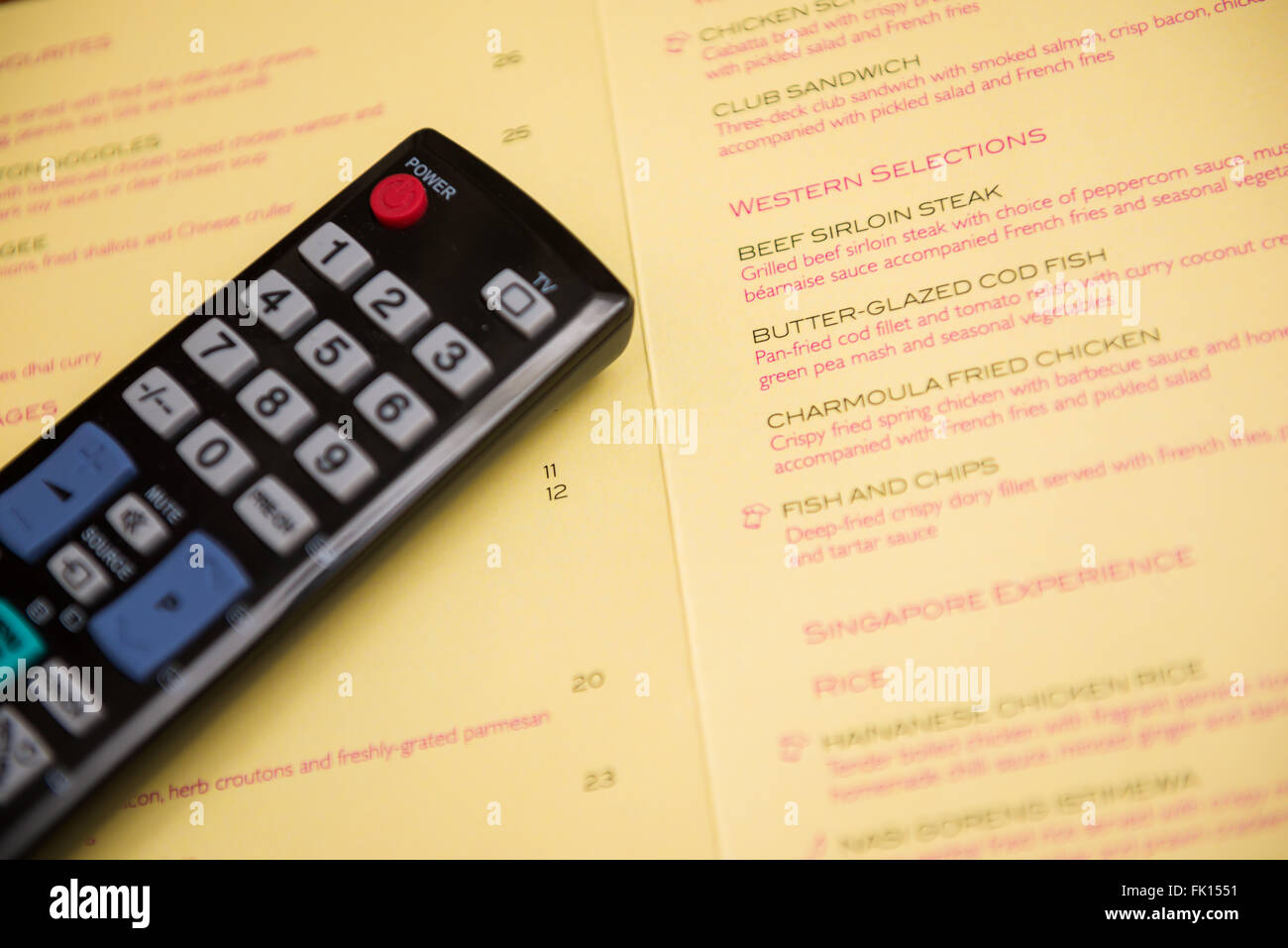 Television remote control on food menu. Food and entertainment concepts ...