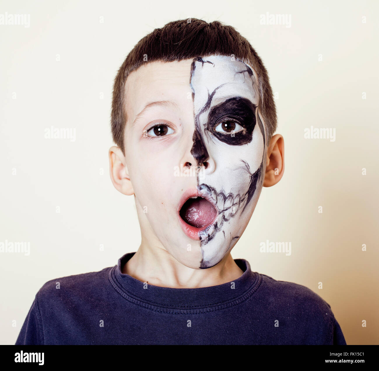 little cute boy with facepaint like skeleton to celebrate halloween ...