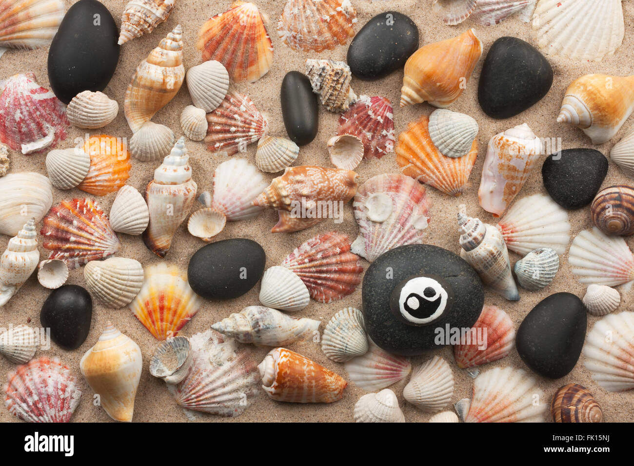 Pyramid yinyang stands on seashells and stones, as background Stock ...