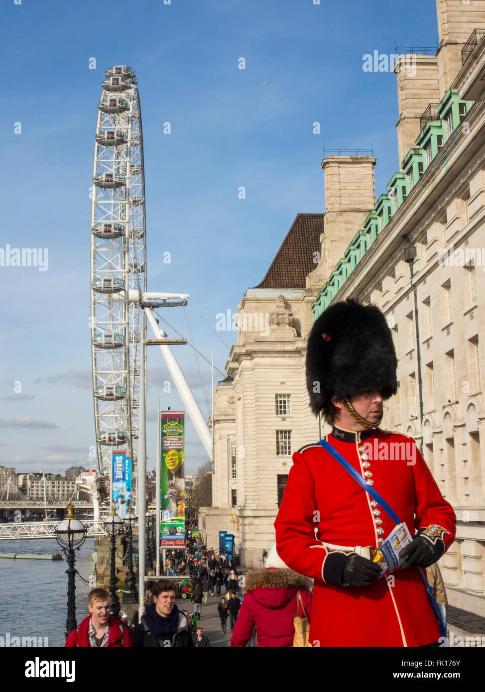 A classic tourist scene of the London Eye with a man dressed as a ...