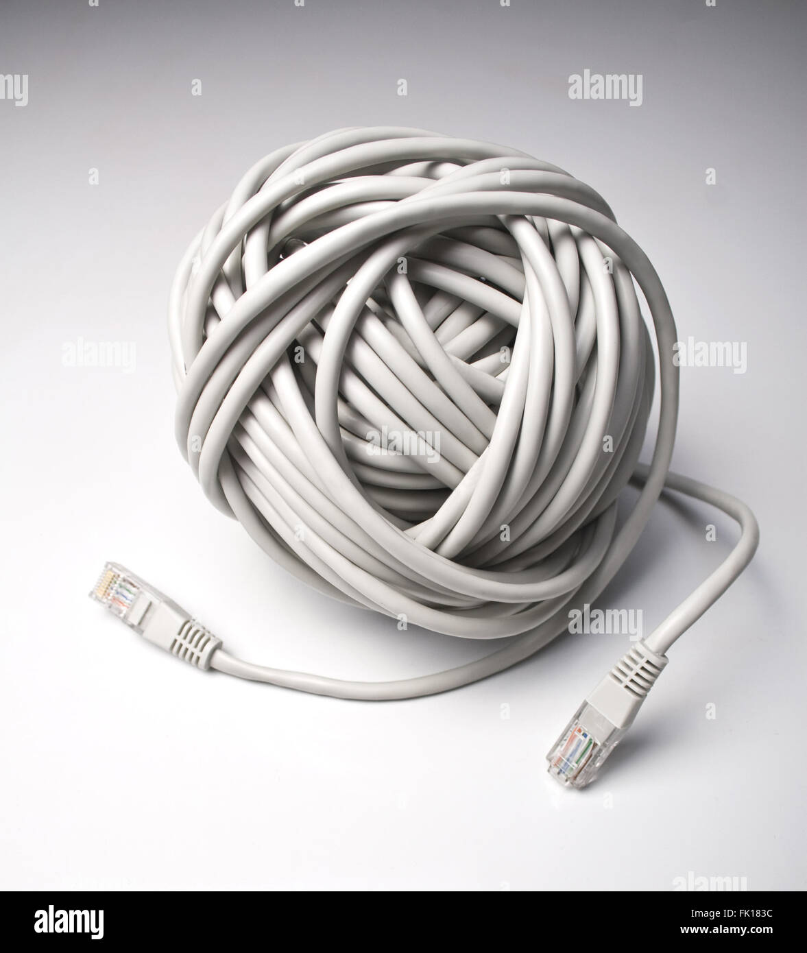 Rolled computer cables on grey background indicating a network problem ...