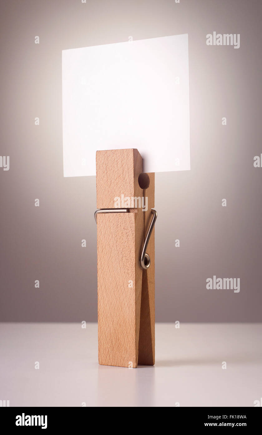 wooden peg holding a white note isolated on grey background Stock Photo ...
