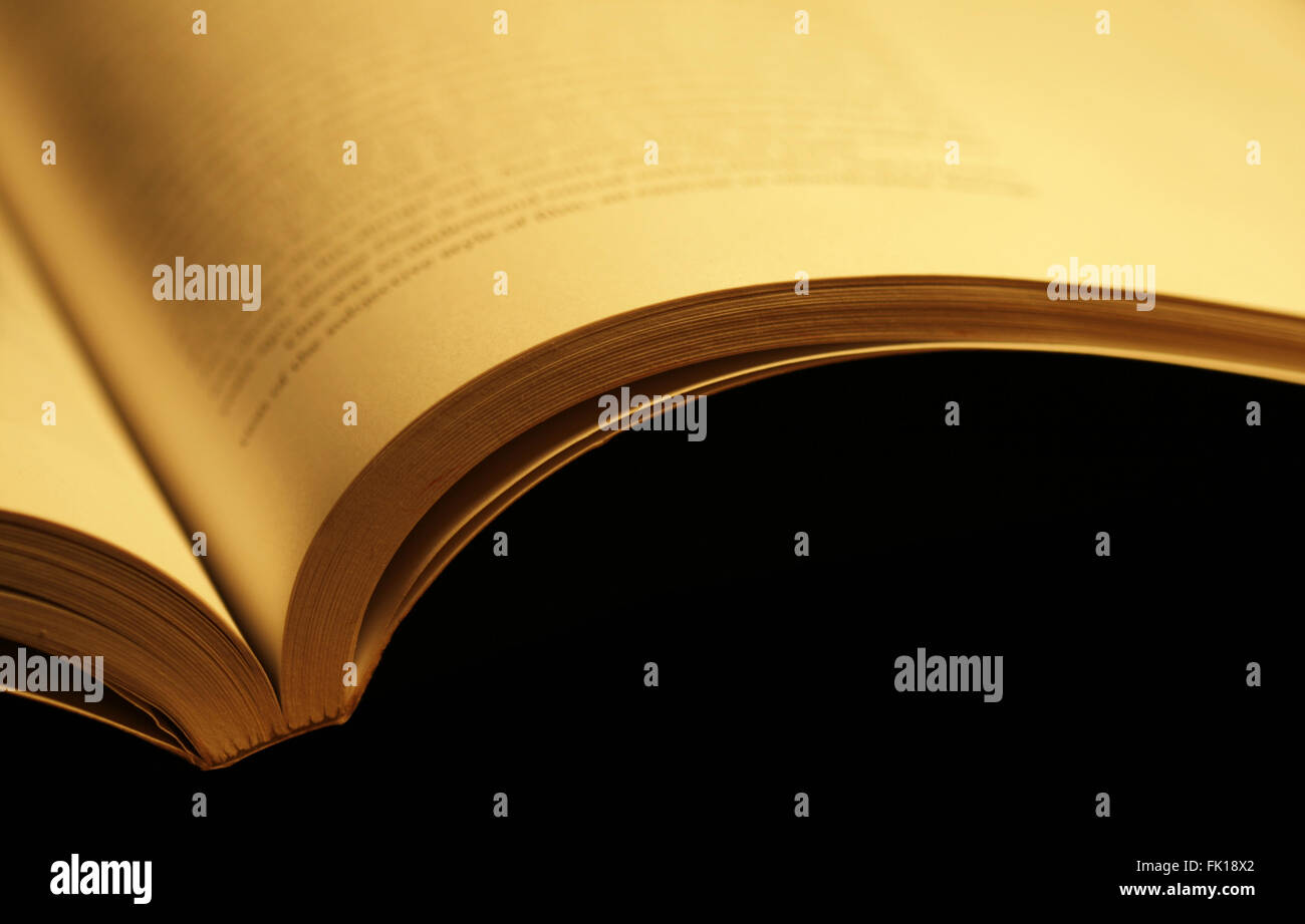 Horizontal photo of an old open book on black background Stock Photo ...