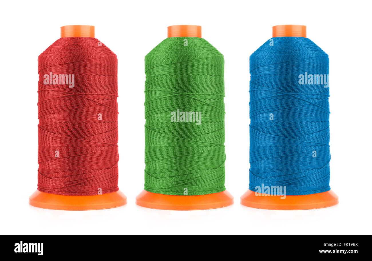 Set of sewing threads in red, blue and green colors isolated on white ...