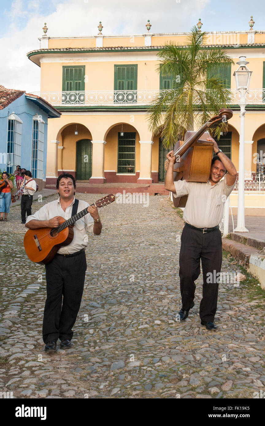 Two musicians carrying their instruments on their way to work in the ...