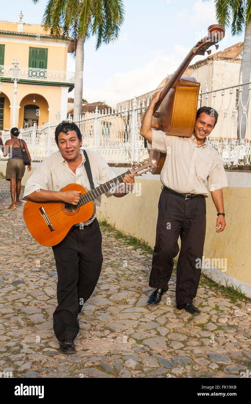 Two musicians carrying their instruments on their way to work in the ...