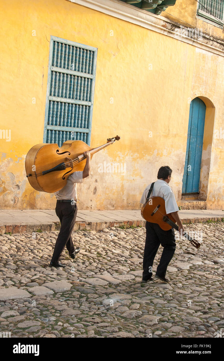 Two musicians carrying their instruments on their way to work in the ...