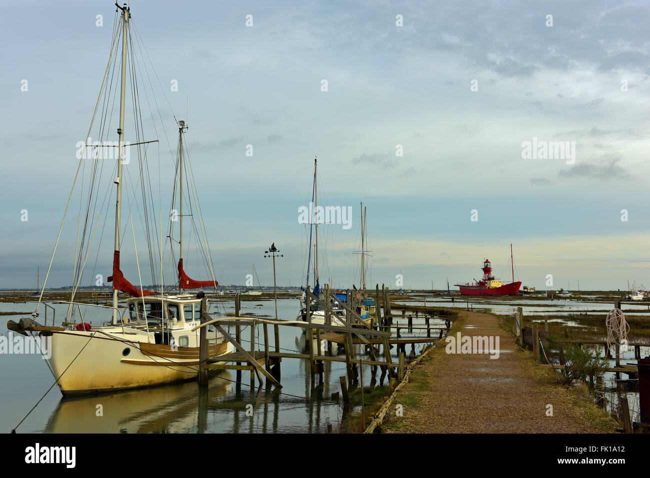 winter scene with walkways through salt marshes accessing the mud ...