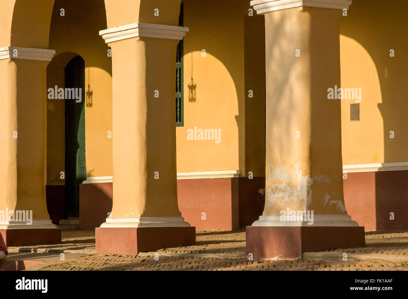 Colonnade of colourful stone columns of a building in colonial town of ...