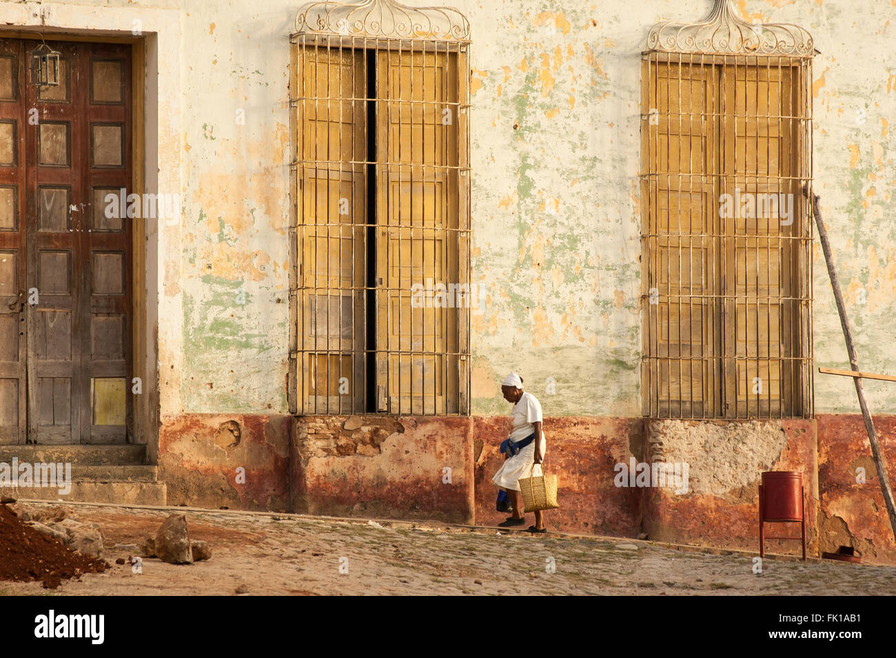Lady walking past windows of colonial house in trinidad hi-res stock ...