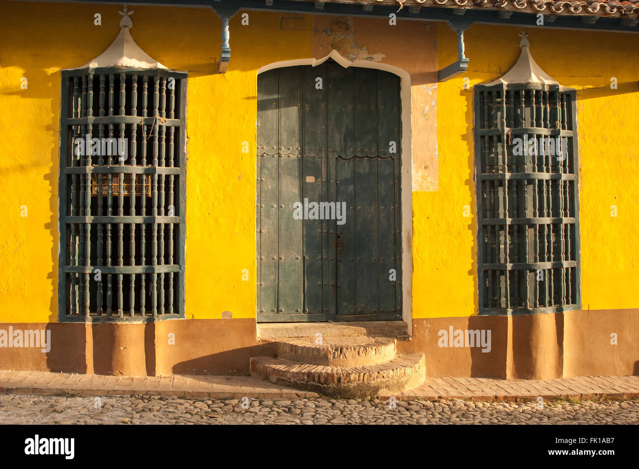 Lady walking past windows of colonial house in trinidad hi-res stock ...