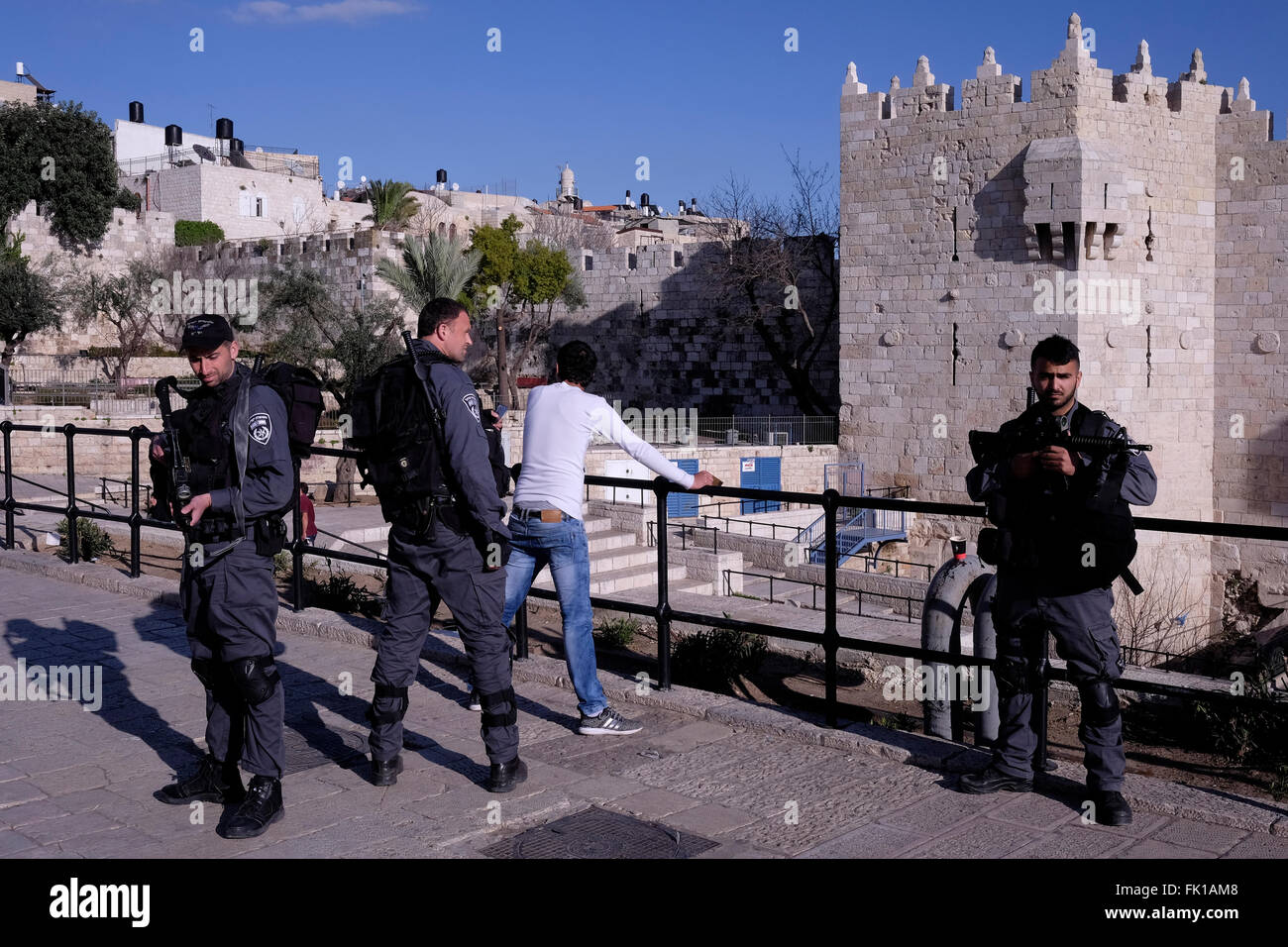 Israeli security forces check young Palestinian man at the entrance of ...