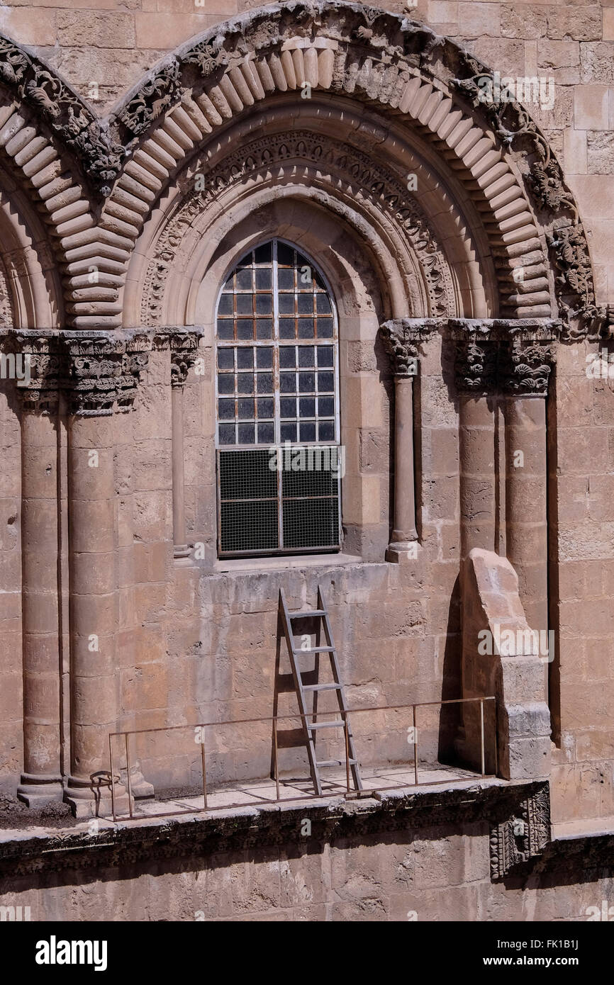 The immovable ladder which leans against a window ledge in the upper ...