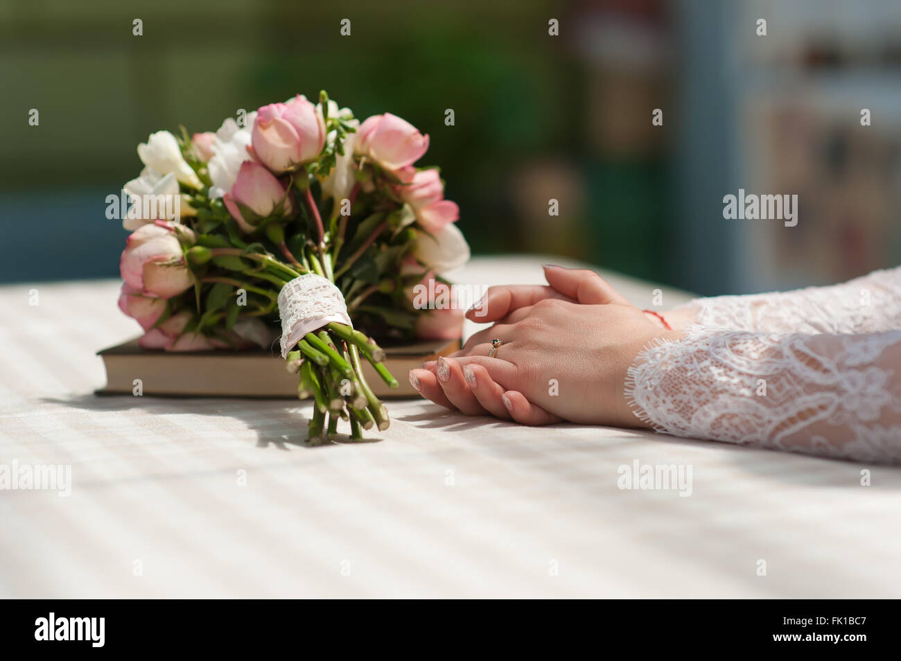 Hands of bride with ring her finger on table Stock Photo - Alamy