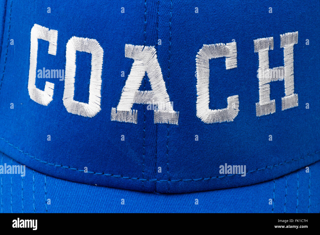 Blue baseball cap with Coach written on it isolated on white background ...