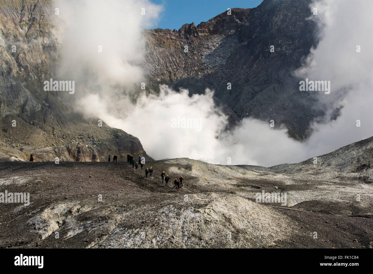 Tourists visiting the steaming crater lake of White Island, a volcano ...