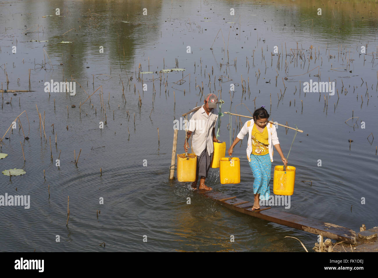 Yangon, Myanmar. 5th Mar, 2016. Residents carry water from a lake at ...