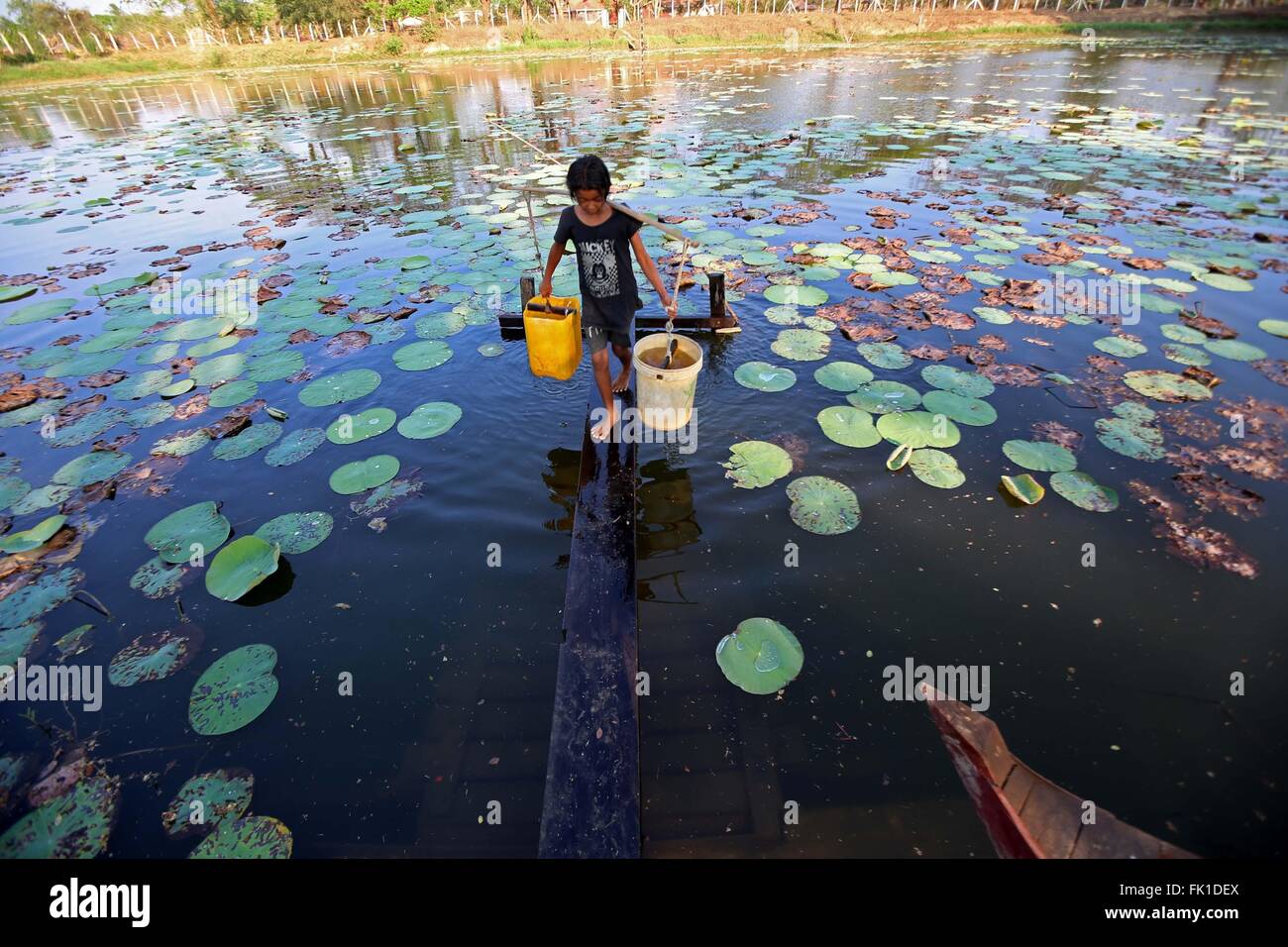 Yangon, Myanmar. 5th Mar, 2016. A resident carries water from a lake at ...
