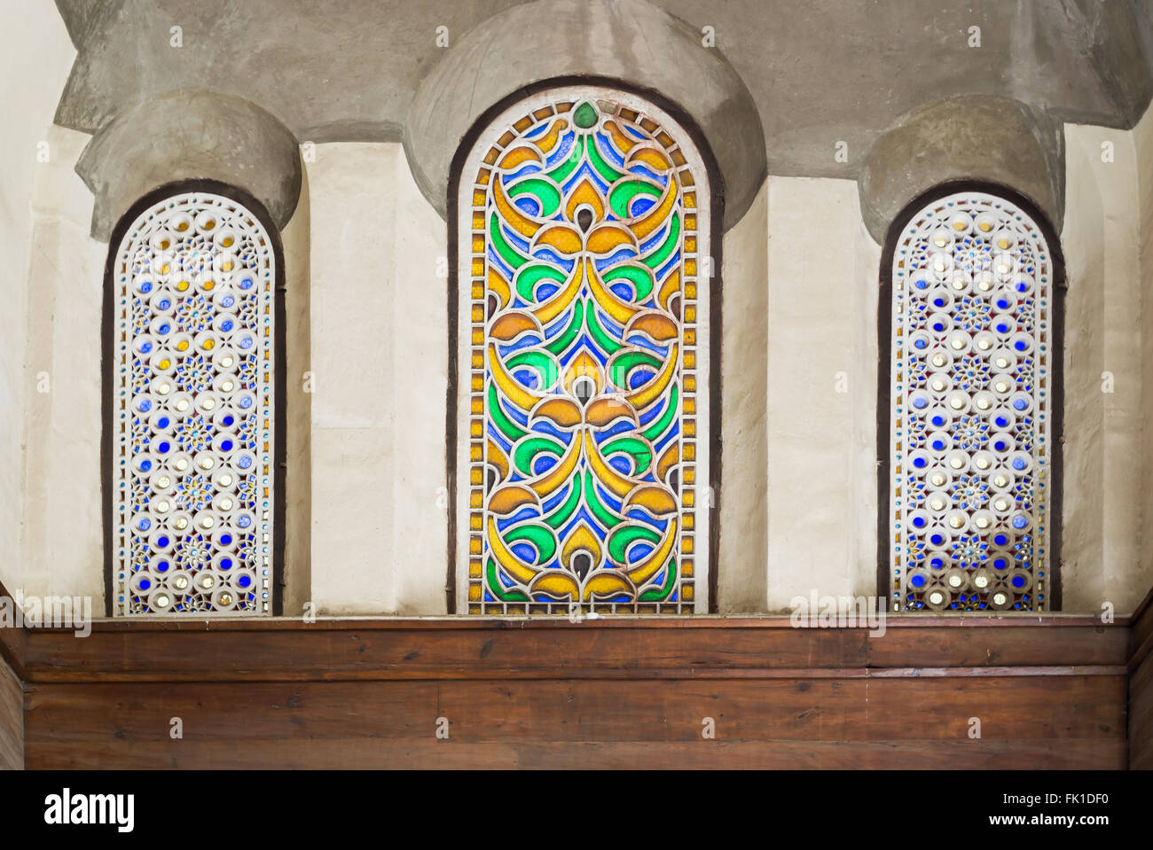 Three adjacent arched stained glass windows in a historic mosque, cairo ...