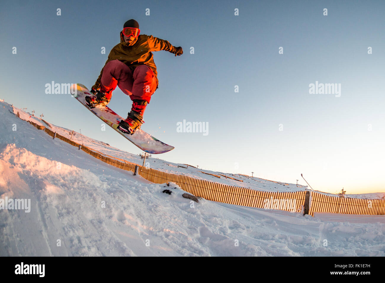 Young man snowboarding in the mountains Stock Photo - Alamy