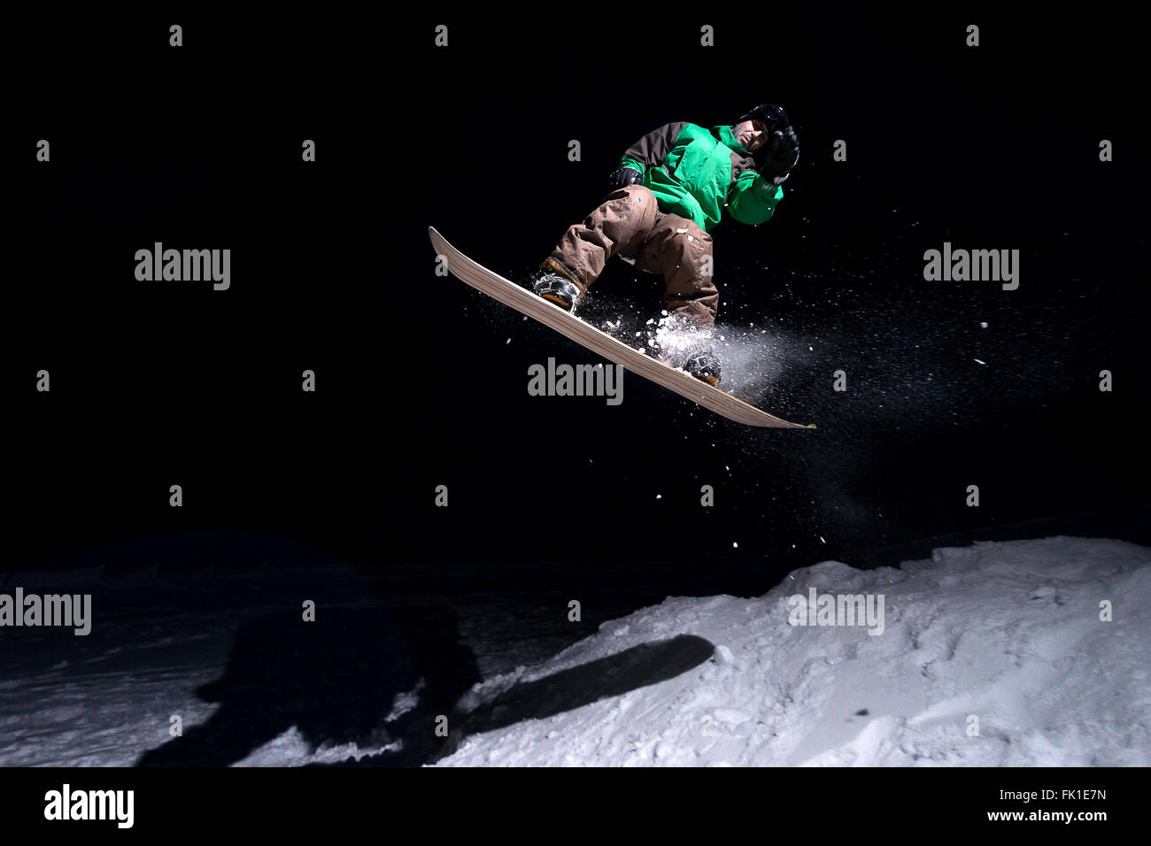 Snowboarder jumping at night Stock Photo - Alamy