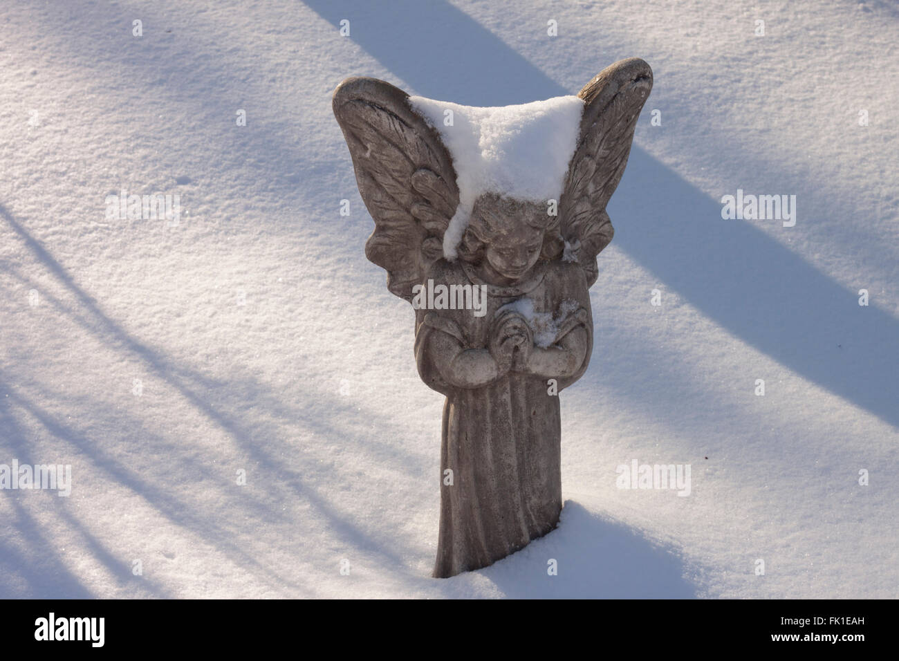 Snowy angel statue in the sunlight Stock Photo - Alamy