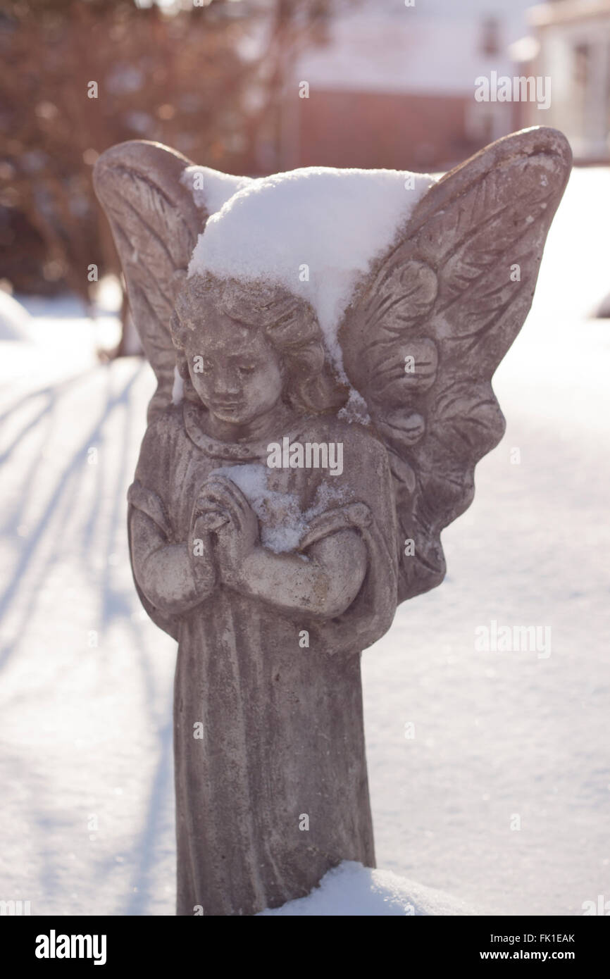 Snowy angel statue in the sunlight Stock Photo - Alamy