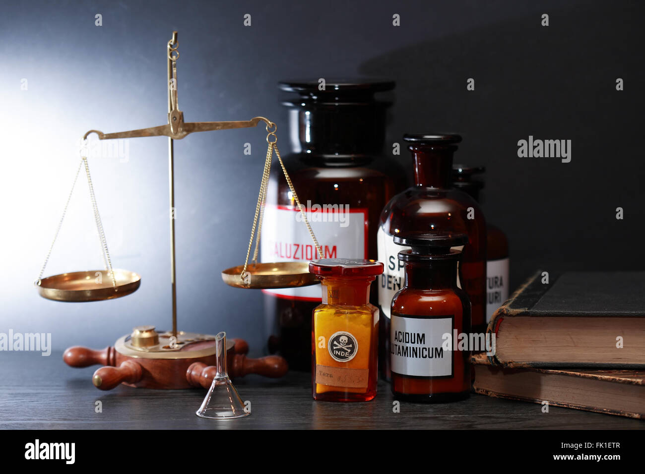 Old pharmaceutical flasks near weight scale and books Stock Photo - Alamy
