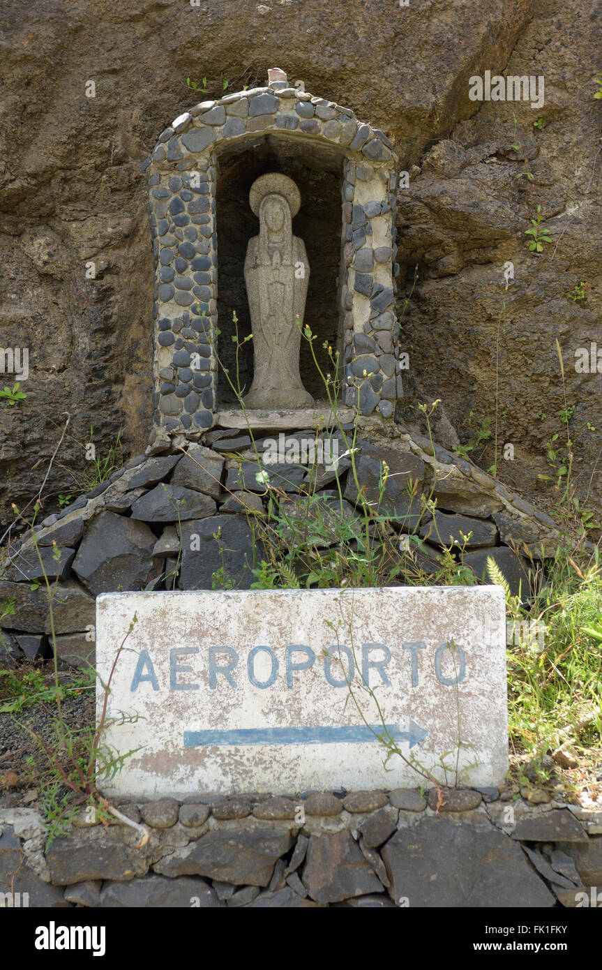 Airport sign beside a religious shrine. Santa Maria Island. Azores ...