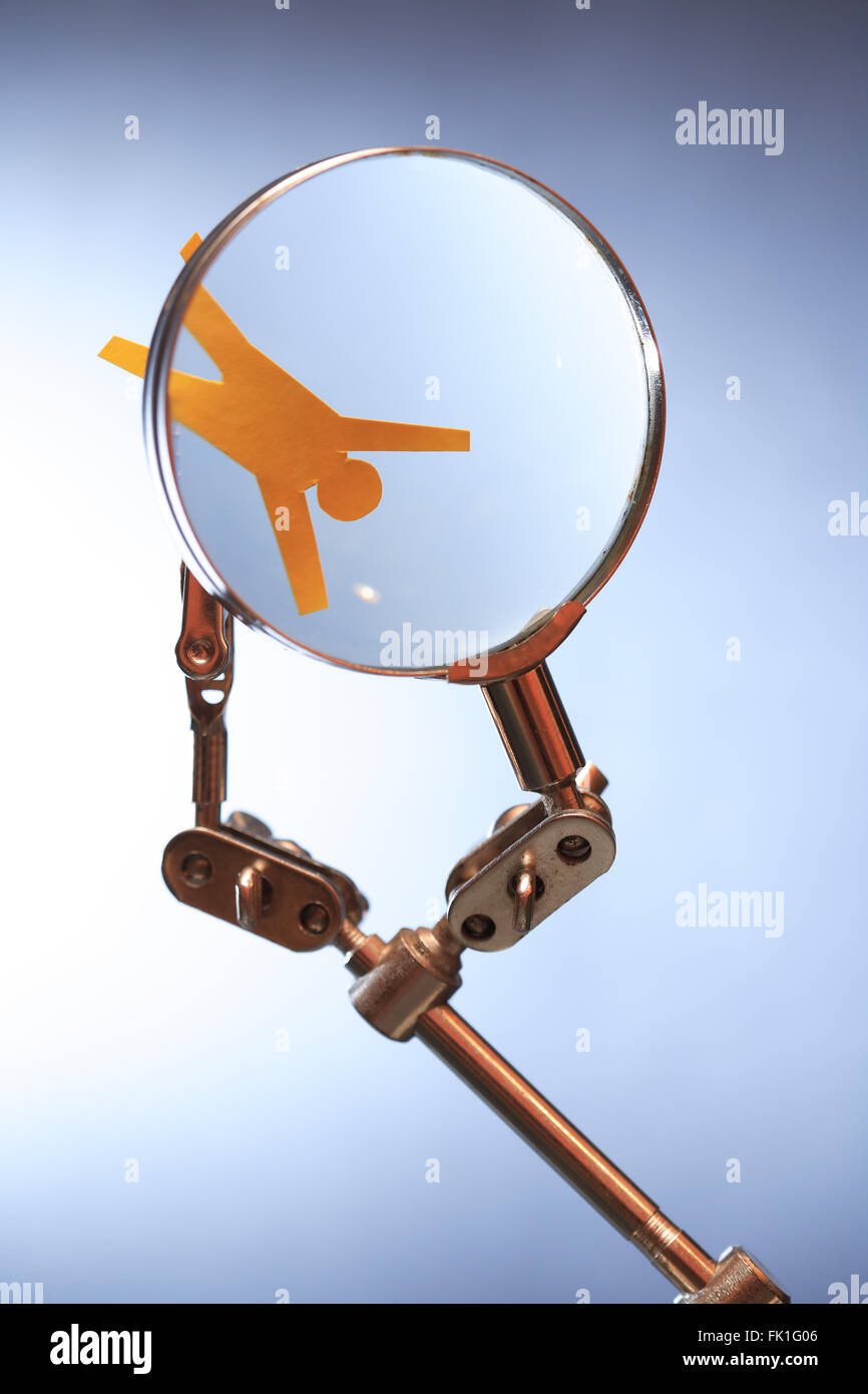 Human rights concept. Yellow paper man in metal clamping device under ...