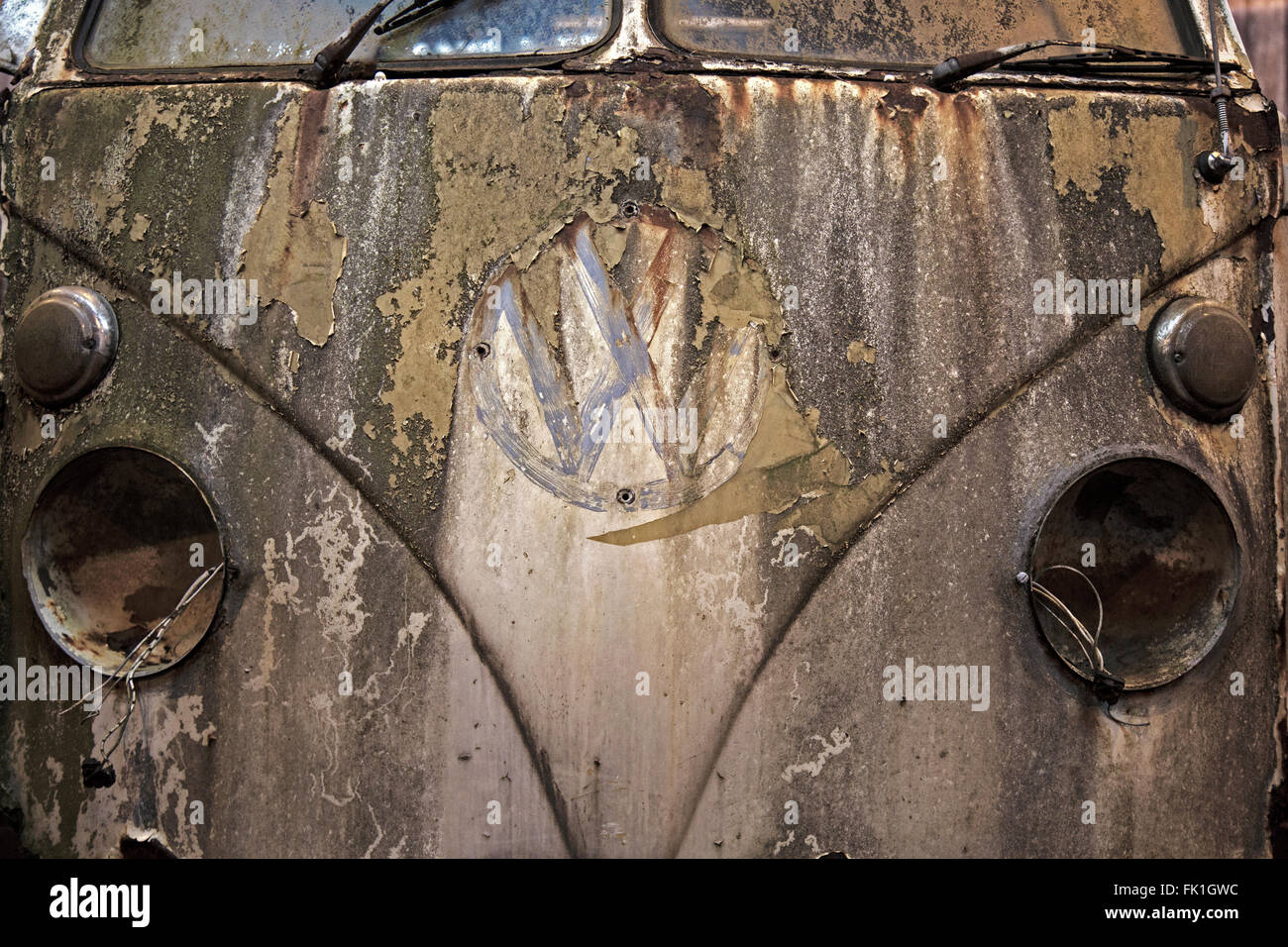 Front of an old Volkswagen Camper van, with peeling paint and missing ...