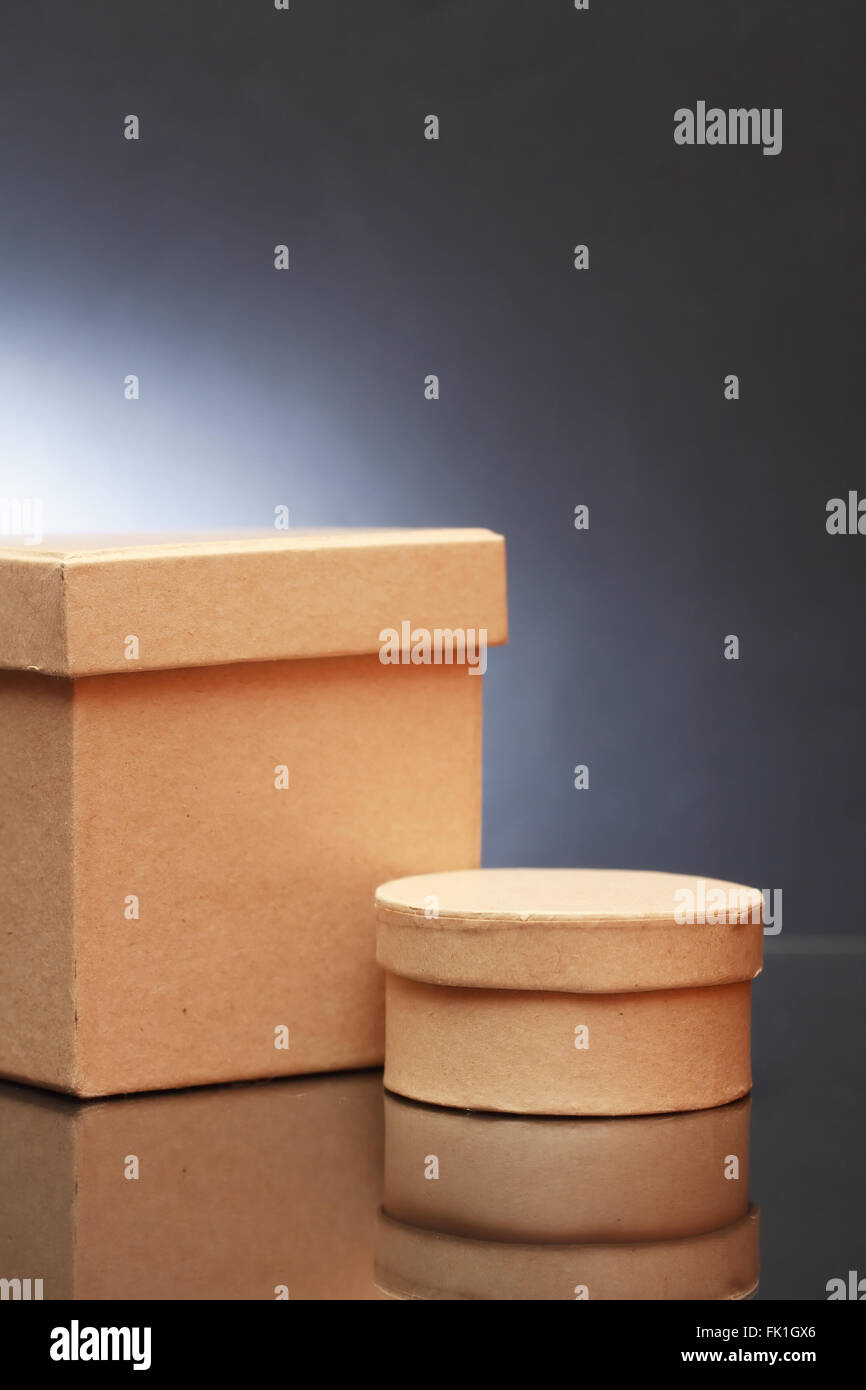 Two closed cardboard boxes with reflection on dark background Stock ...