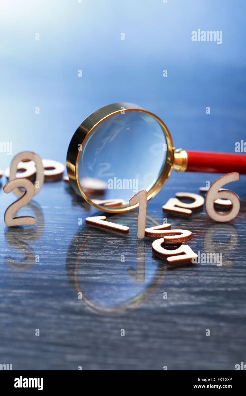 Investigation concept. Magnifying glass near set of wooden digits Stock ...