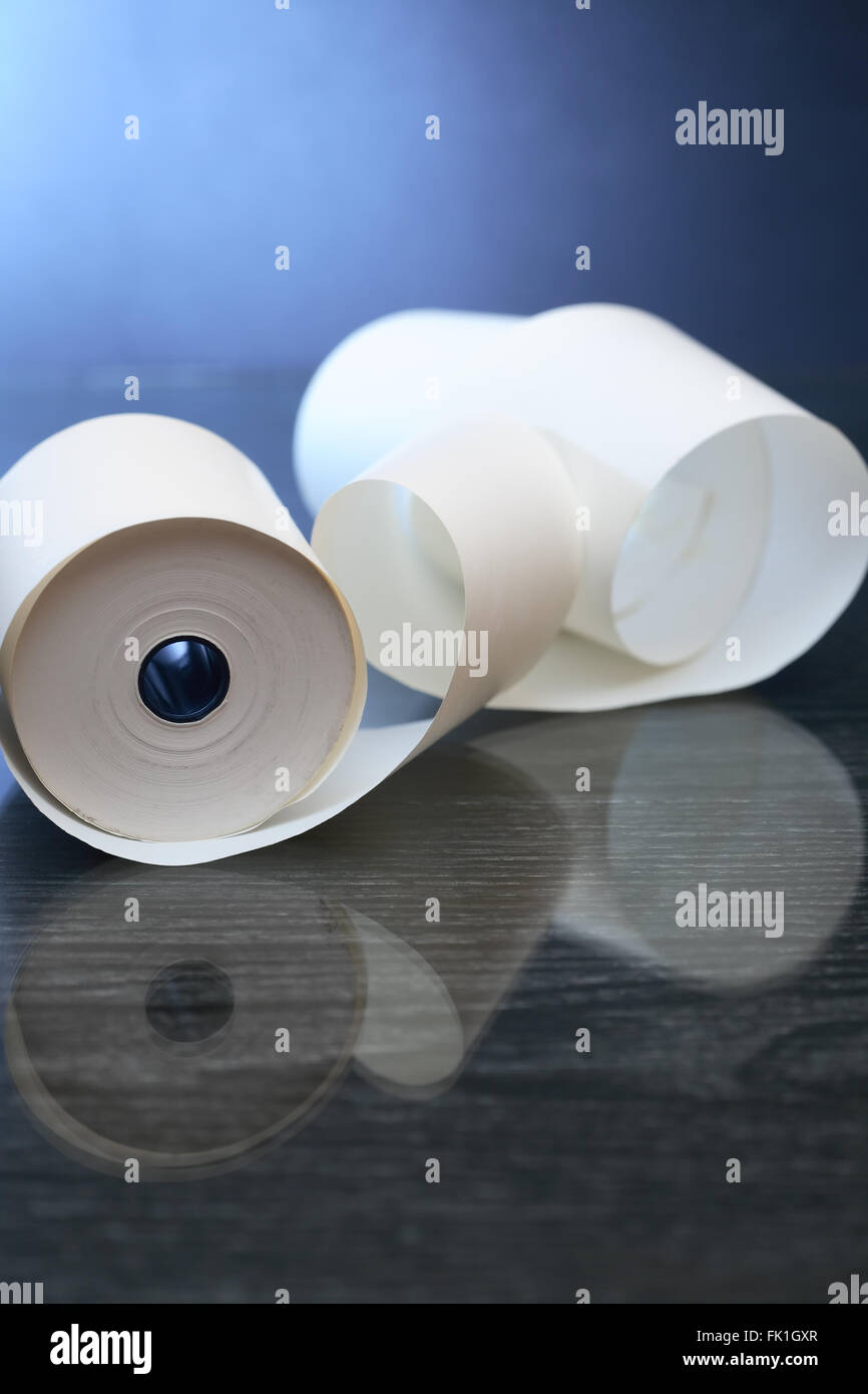 White paper roll with reflection on dark background Stock Photo - Alamy