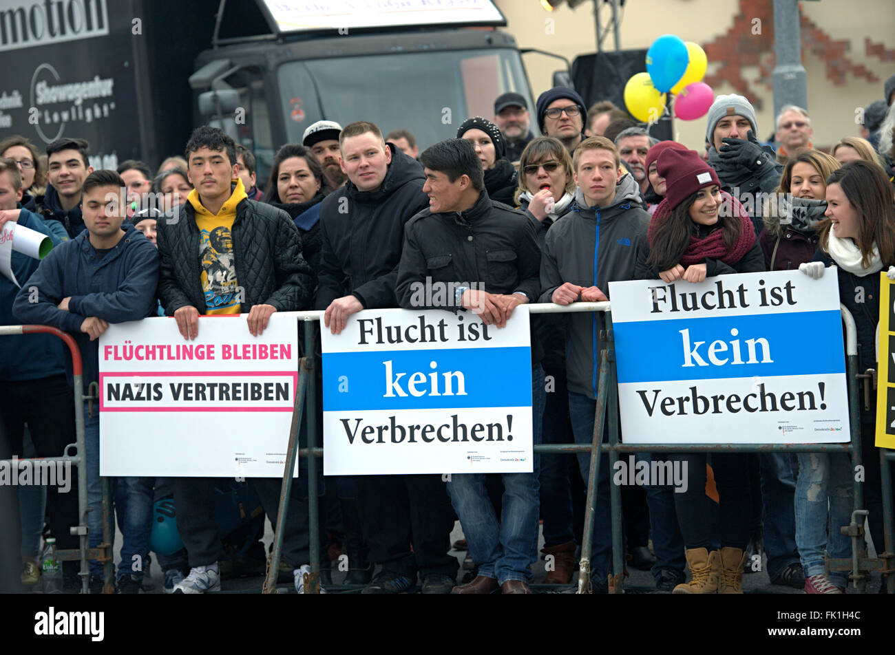 Rathenow, Germany. 05th Mar, 2016. People hold up balloons and posters ...