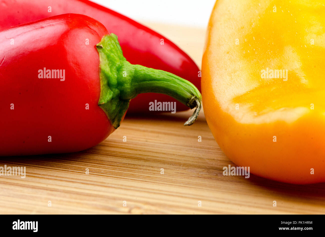A mix of colored peppers on the cutting board Stock Photo - Alamy