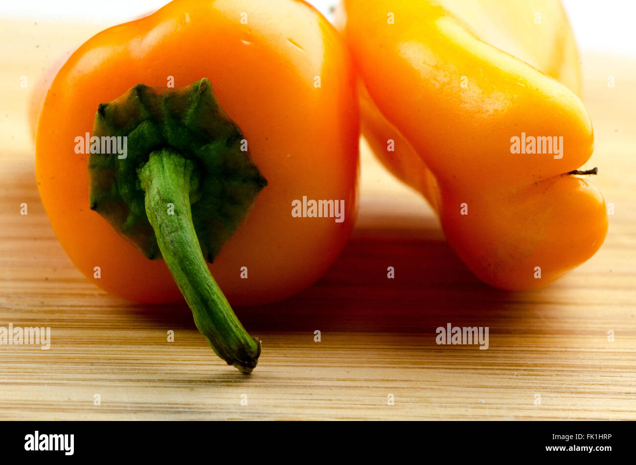 A mix of colored peppers on the cutting board Stock Photo - Alamy