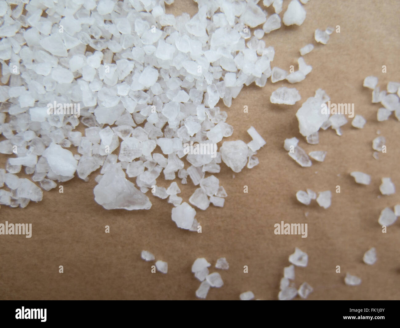 Natural sea salt on parchment closeup Stock Photo - Alamy