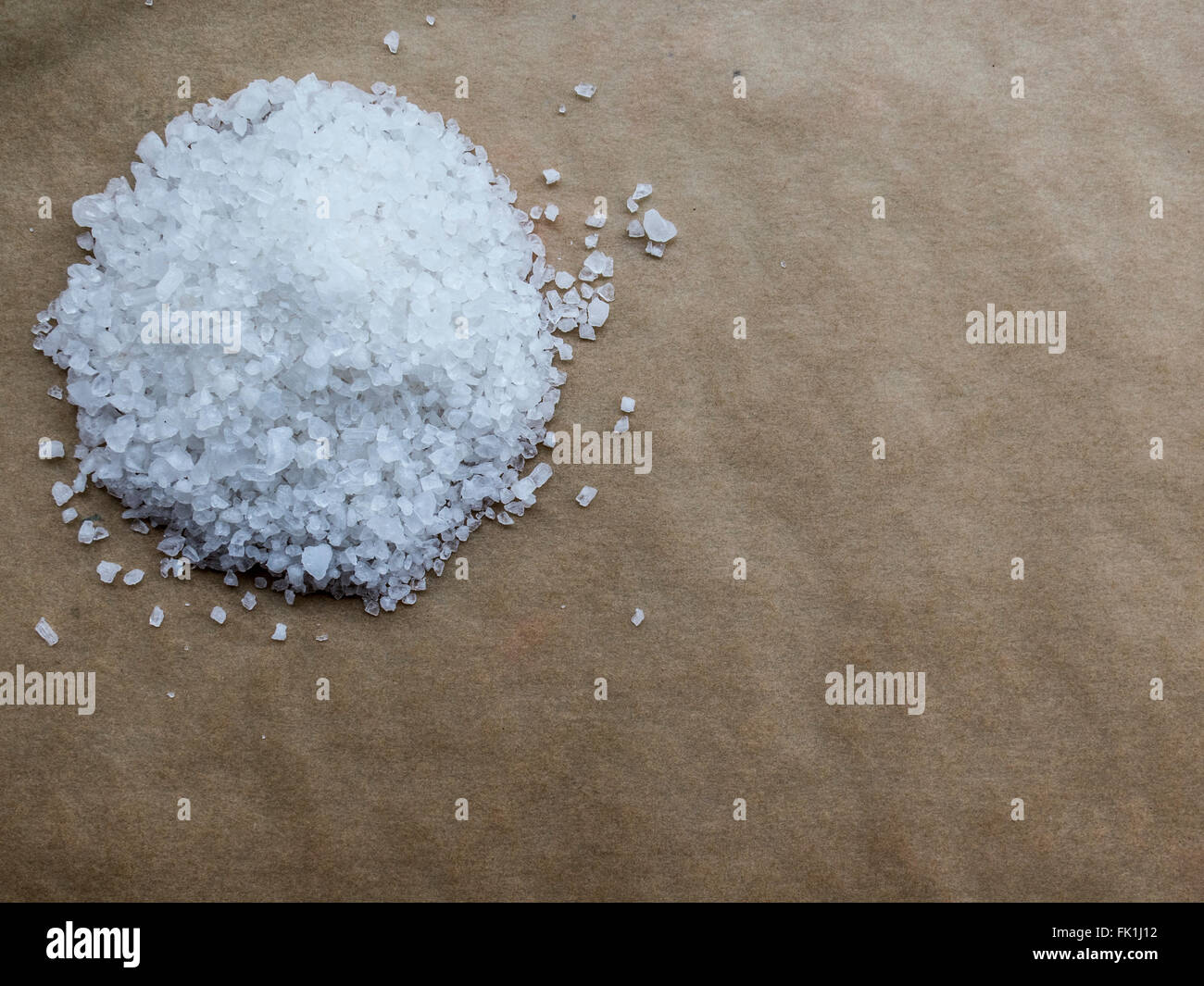 bunch of sea salt in a natural color Kraft paper Stock Photo - Alamy