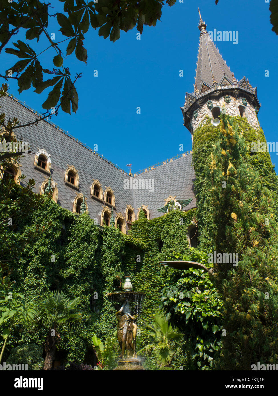 Fairytale castle with lush green garden and fountain Stock Photo - Alamy