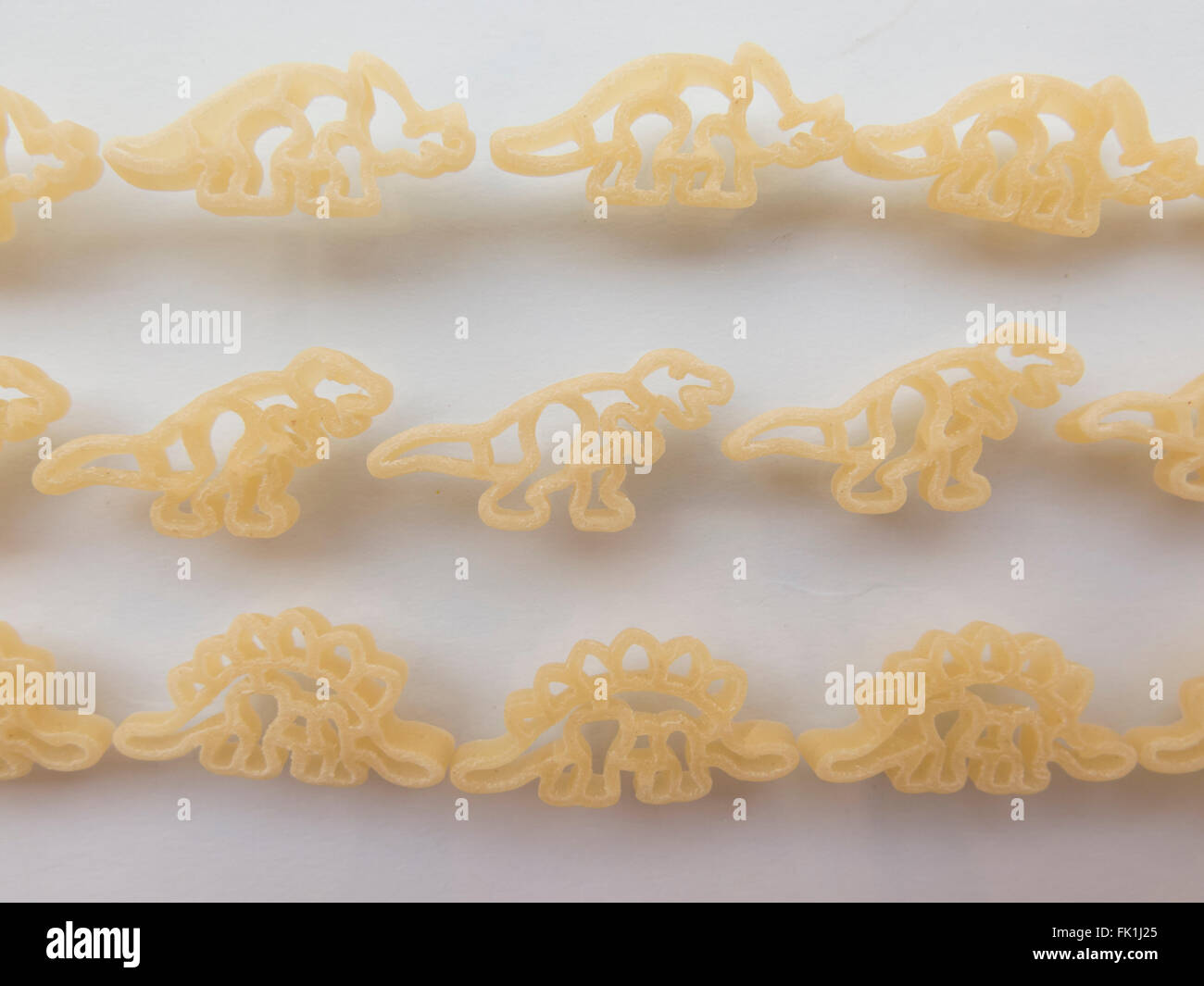 Pasta-dinosaurs on a white background Stock Photo - Alamy