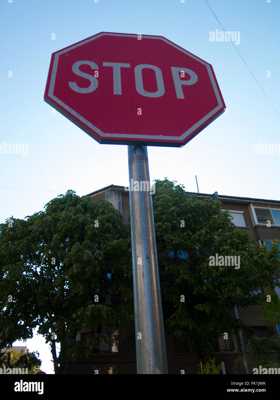 A red stop sign, a bottom view, on the background of clear blue sky and ...