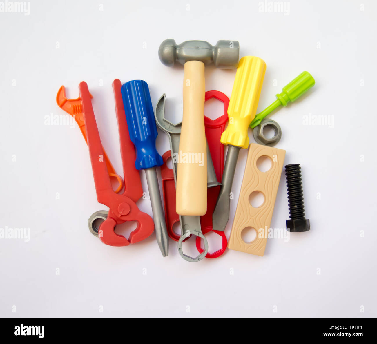 colored set of plastic tools, gathered in a pile on a white background ...