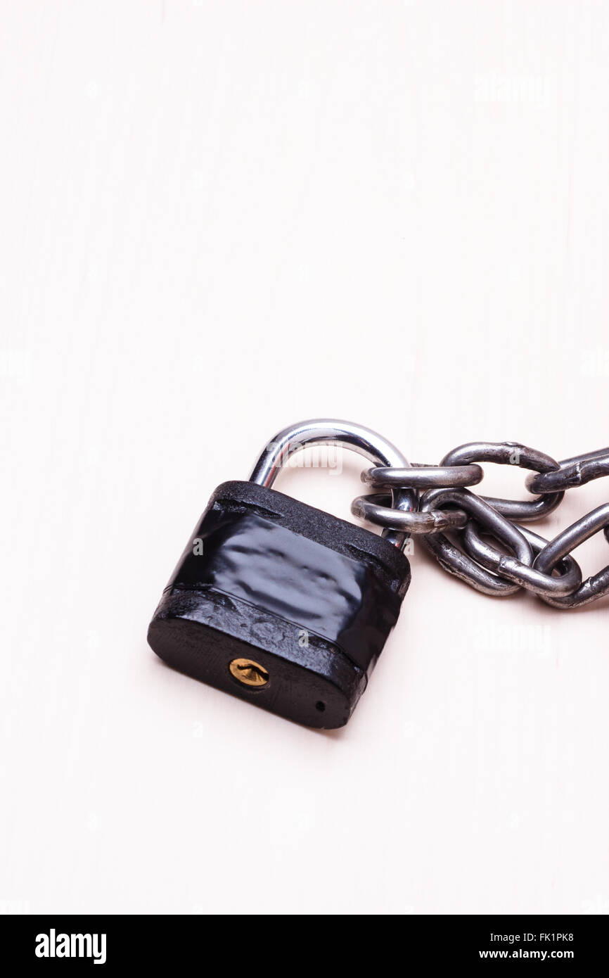 Security concept. Black padlock and iron chain Stock Photo - Alamy