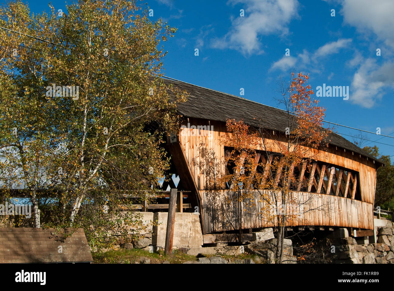 Lattice truss construction of Squam River covered bridge on a colorful ...