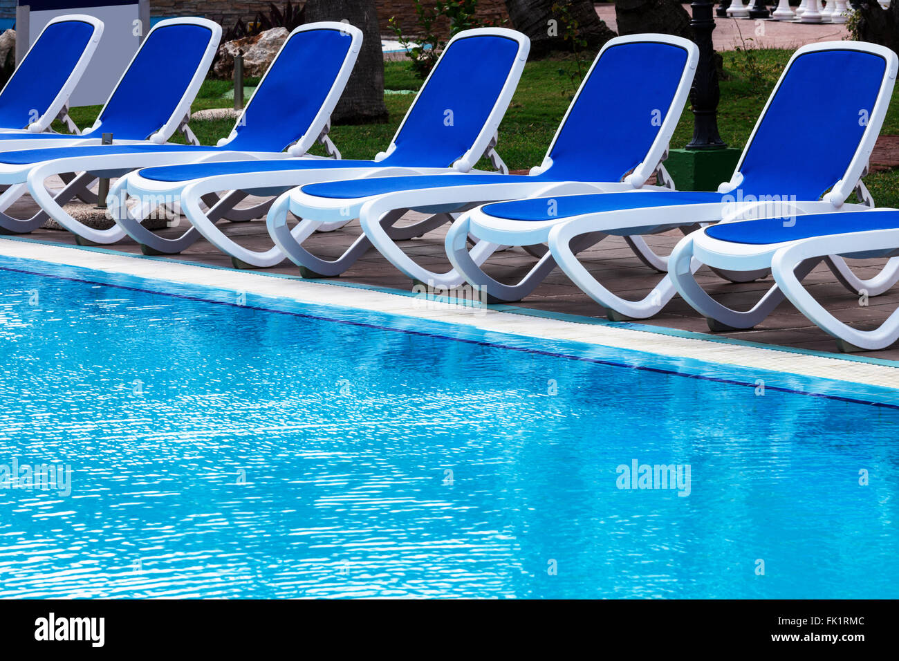 blue lounge chairs by the pool Stock Photo - Alamy