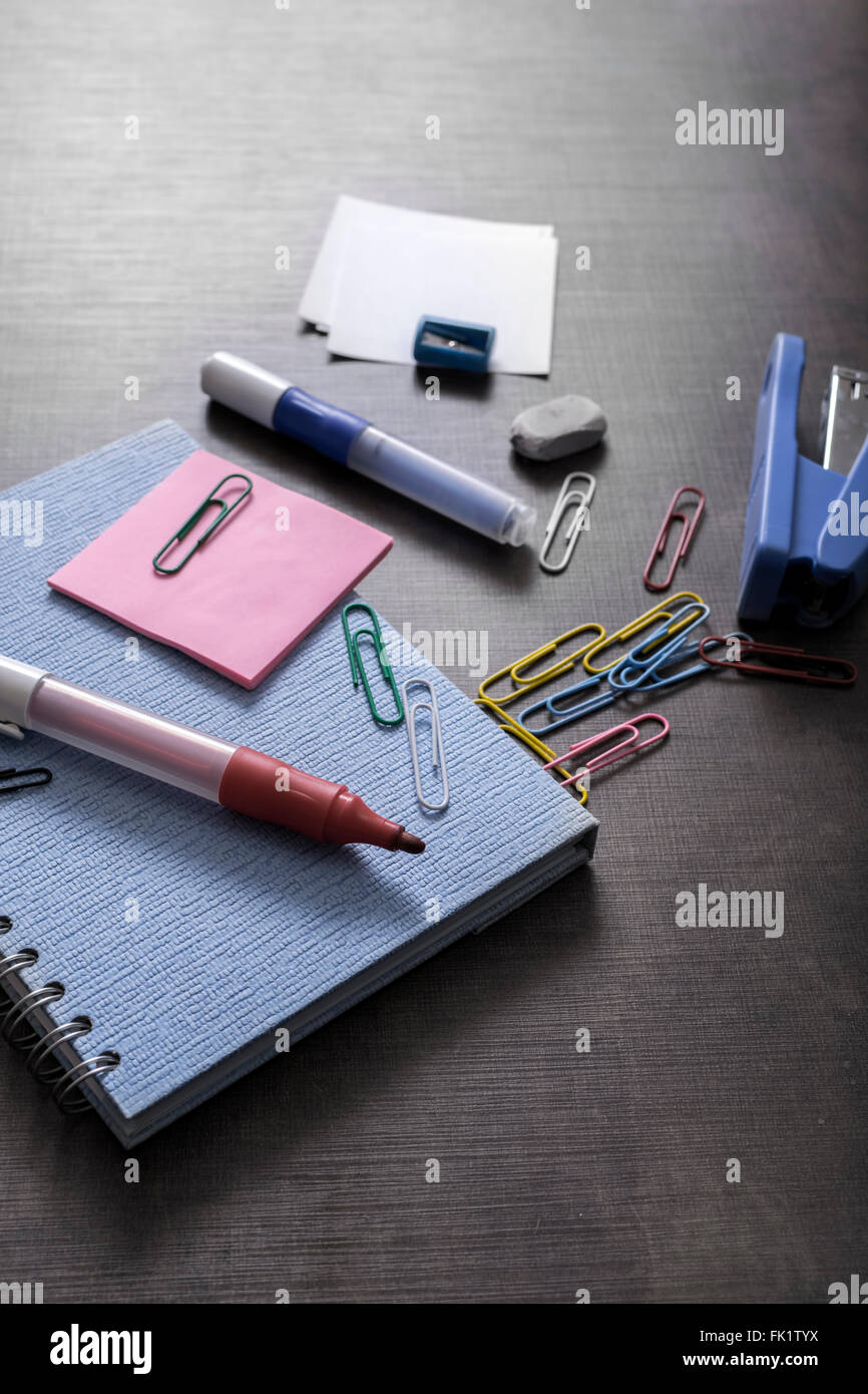 Mix of office supplies on a wooden desk background. Close up Stock ...