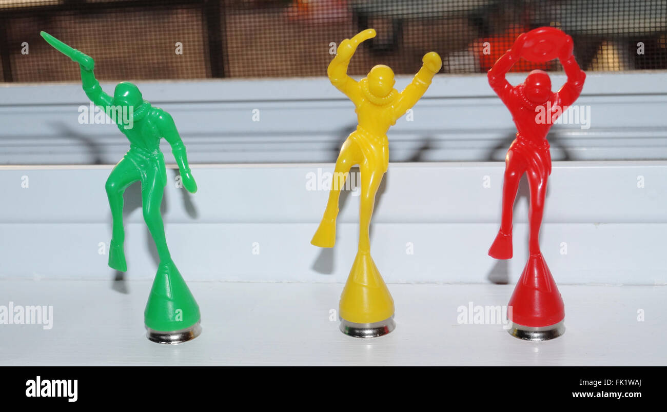 3 colored toys on the window sill Stock Photo - Alamy