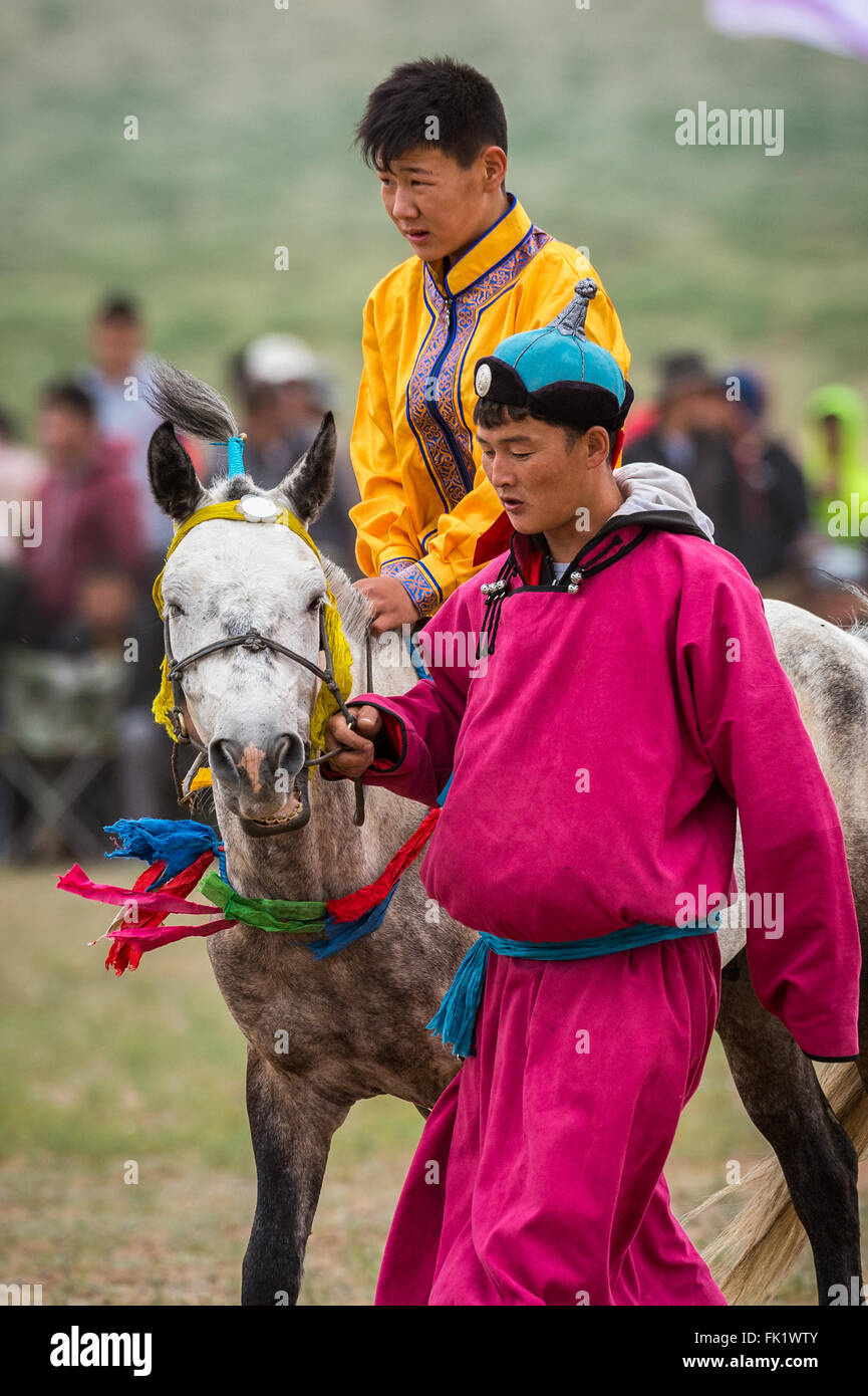 Man leading a boy on a horse to the starting line Stock Photo - Alamy